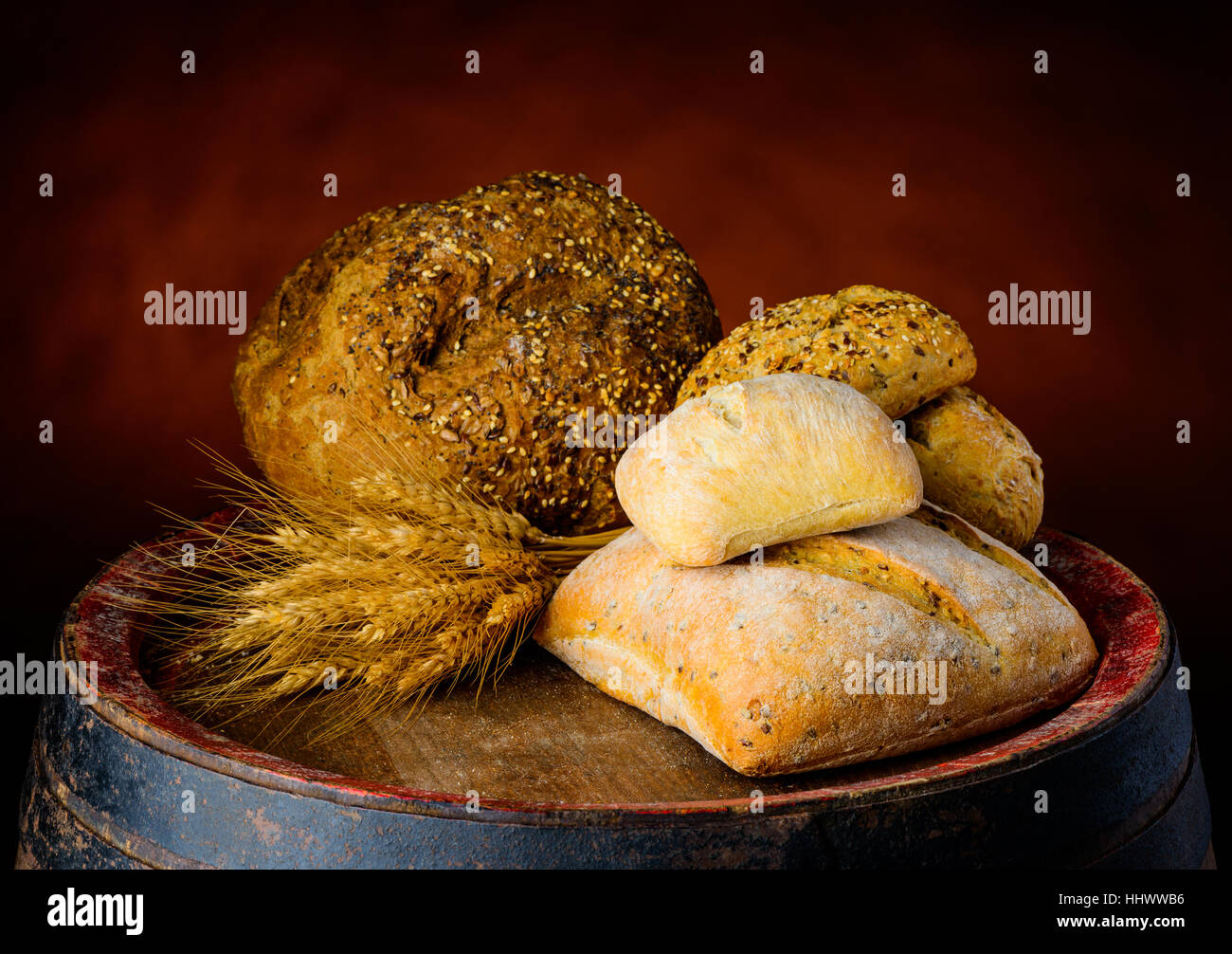 Different bread types and bun on wooden barrel. rustic, traditional ...