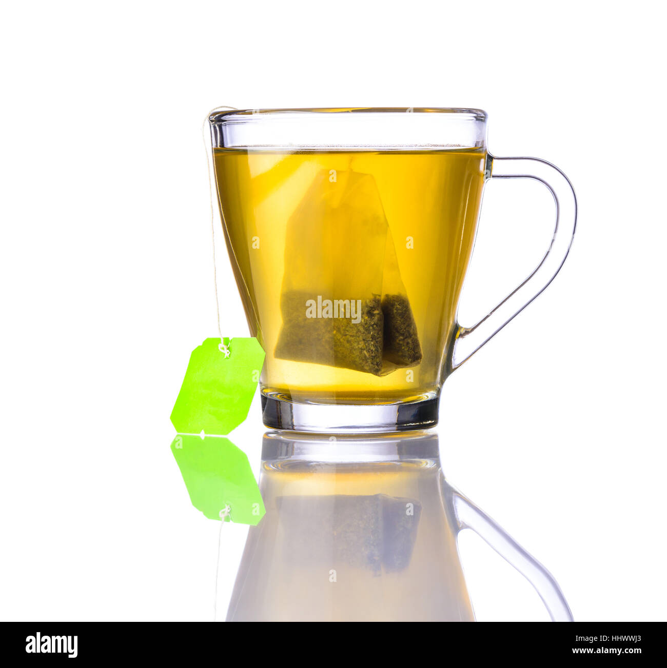 Single Tea cup and bag in glass-cup with yellow tea isolated on white ...