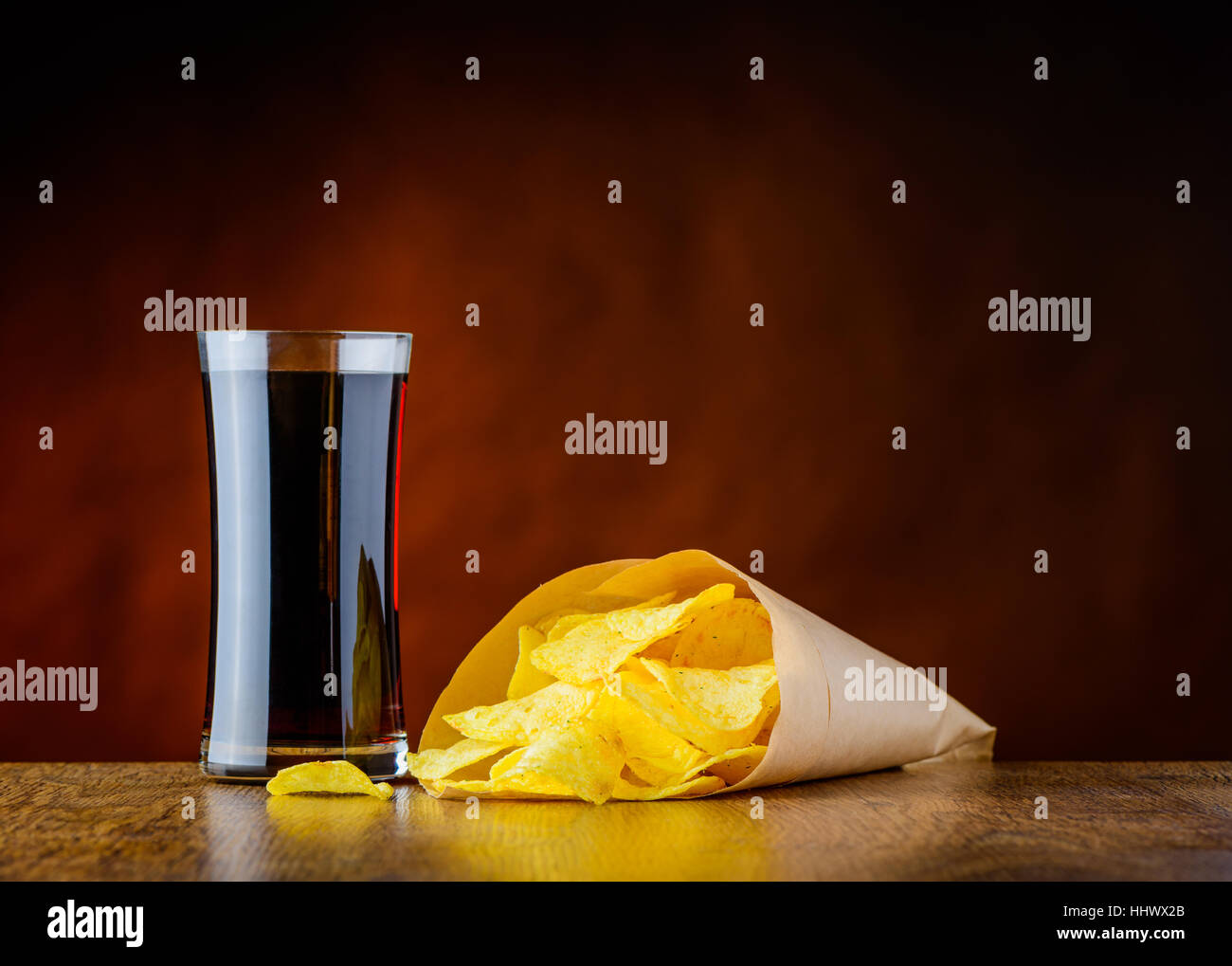 Glass of Cola with paper bag of Potato-chips Stock Photo - Alamy