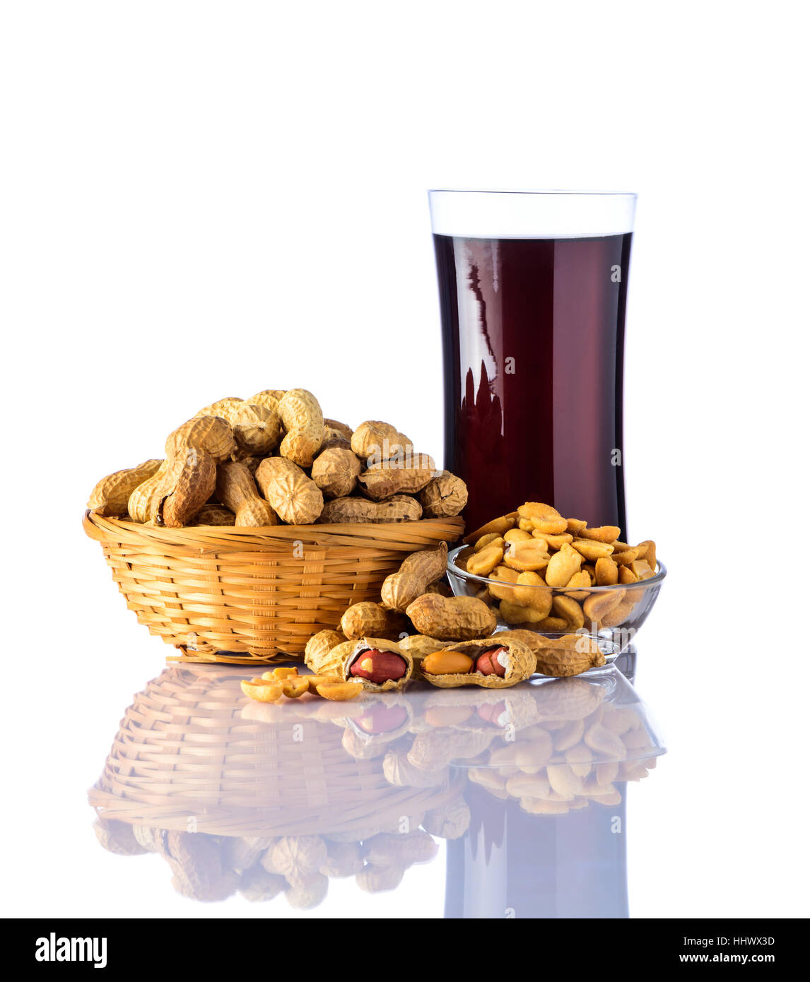 Basket of peanuts and one glass of cola isolated on white background ...