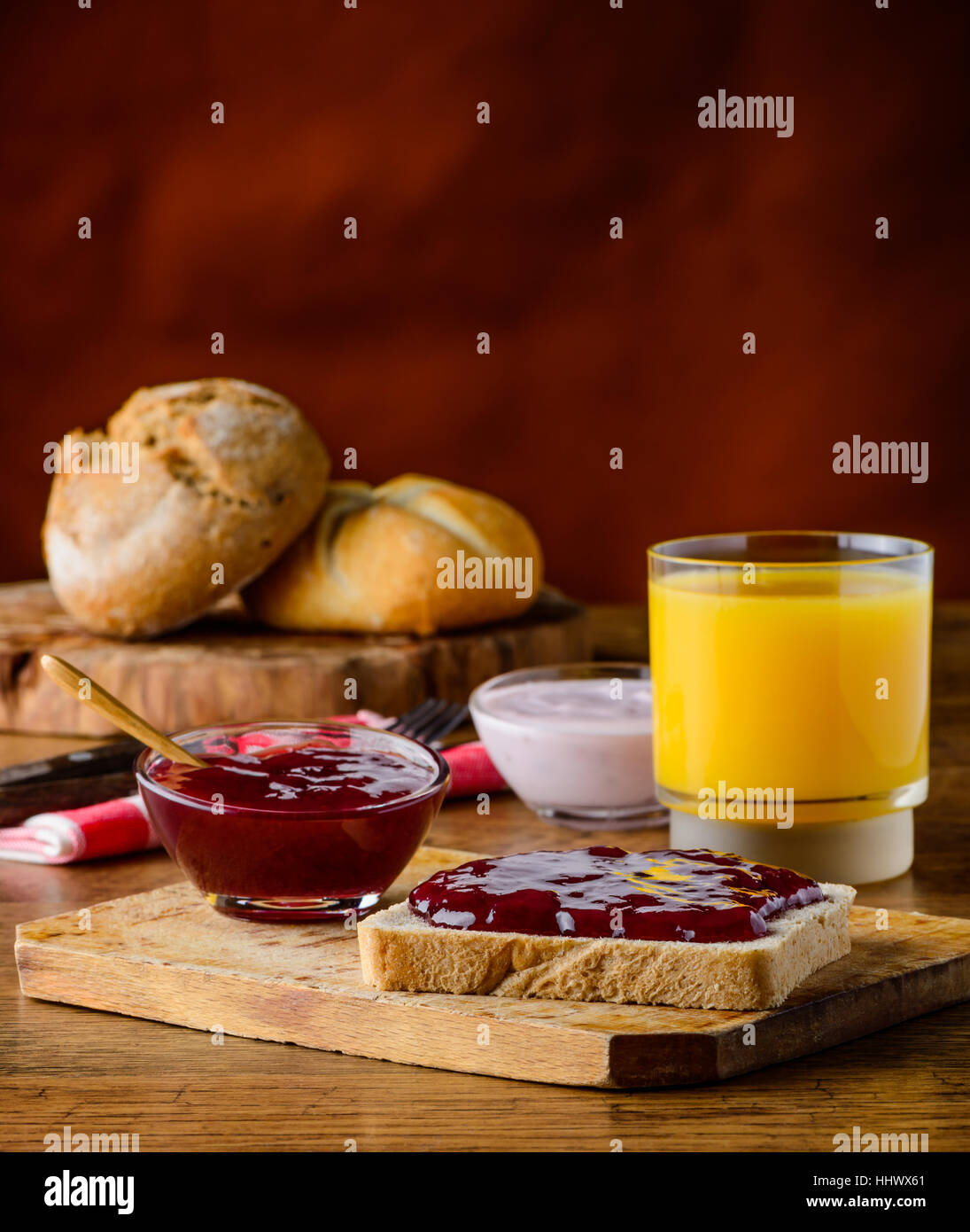 Fruit Jam spread on bread and glass of orange juice Stock Photo - Alamy