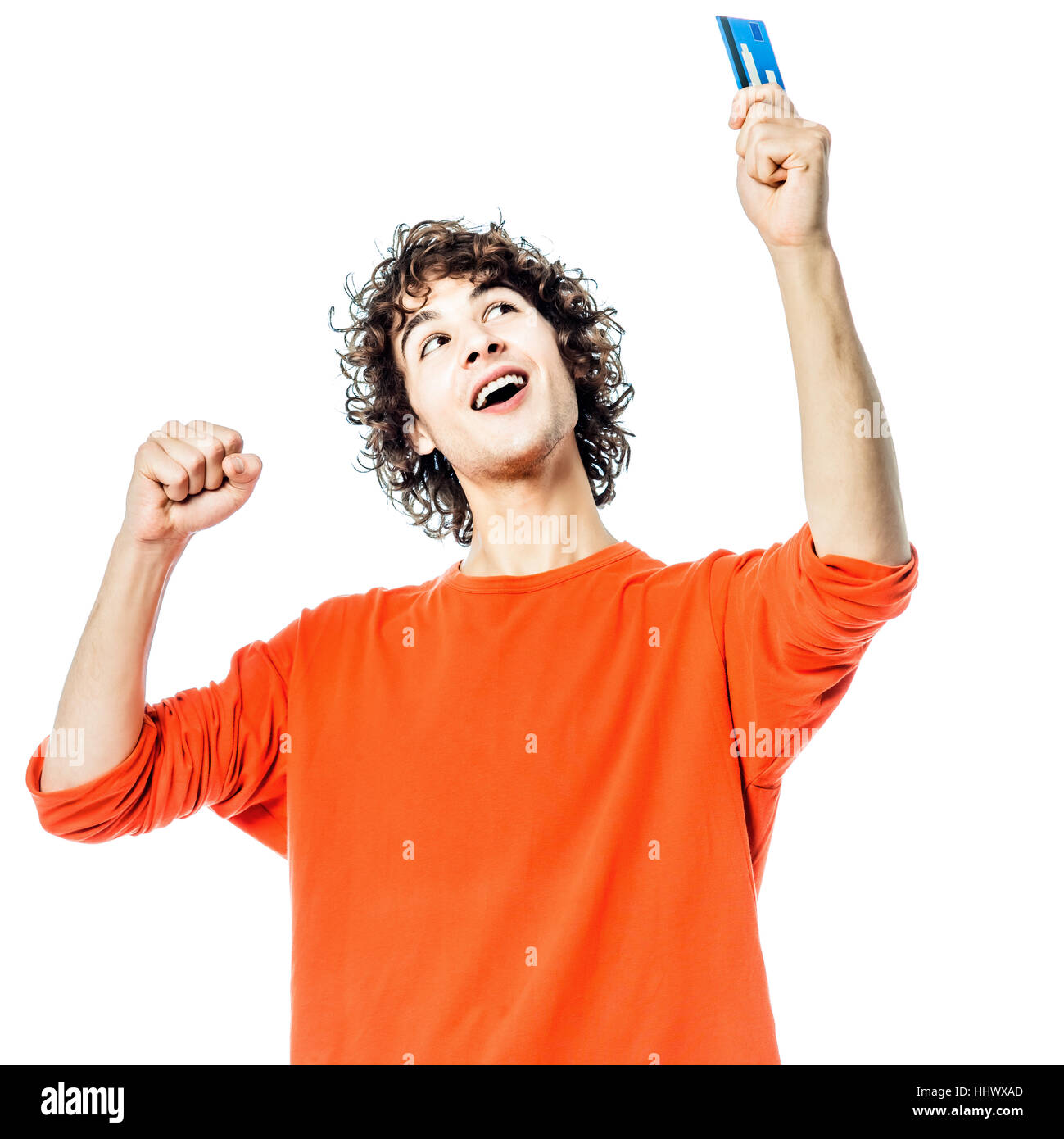 one young man caucasian happy holding credit card portrait in studio ...