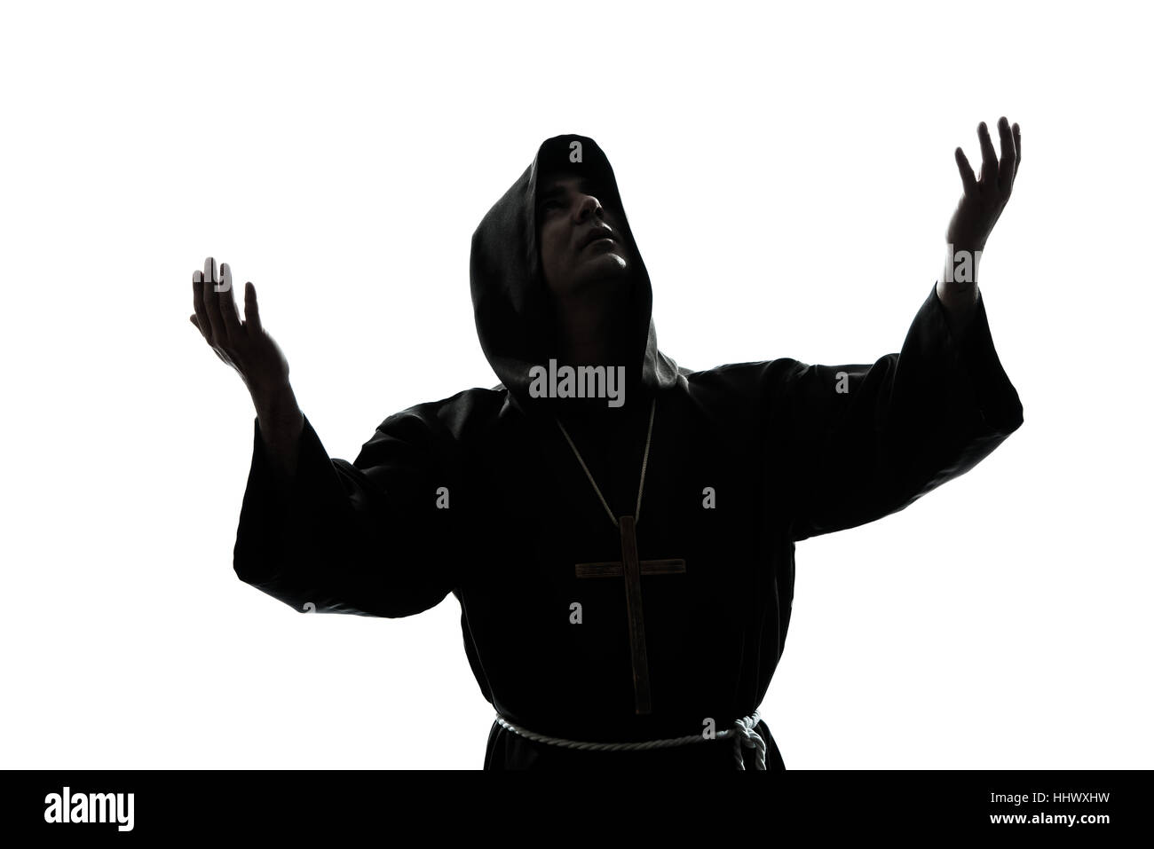one caucasian man priest praying silhouette in studio isolated on white ...