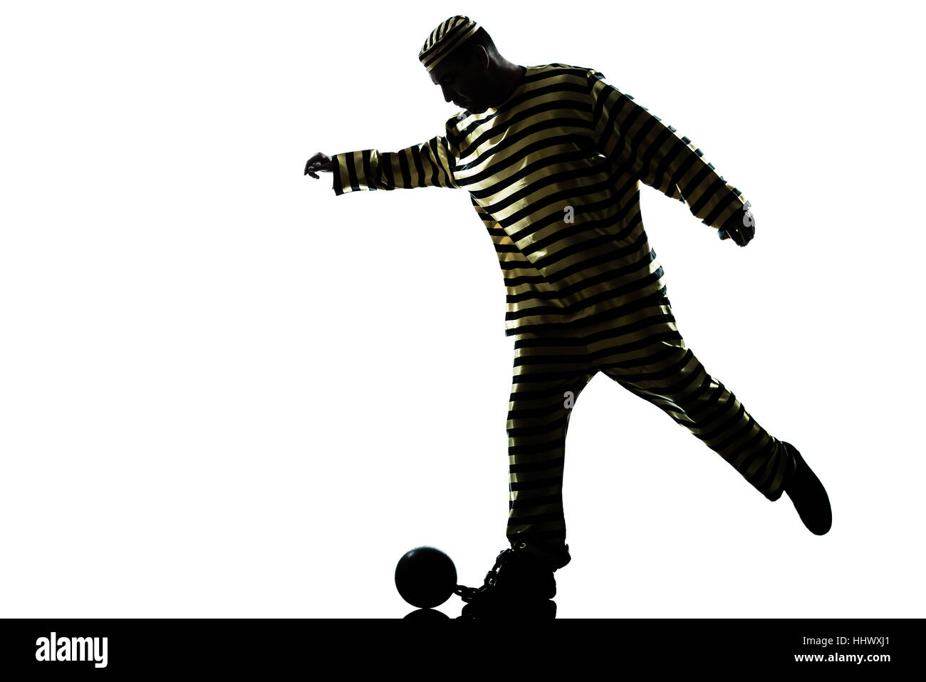 one caucasian man prisoner criminal playing soccer with chain ball in ...