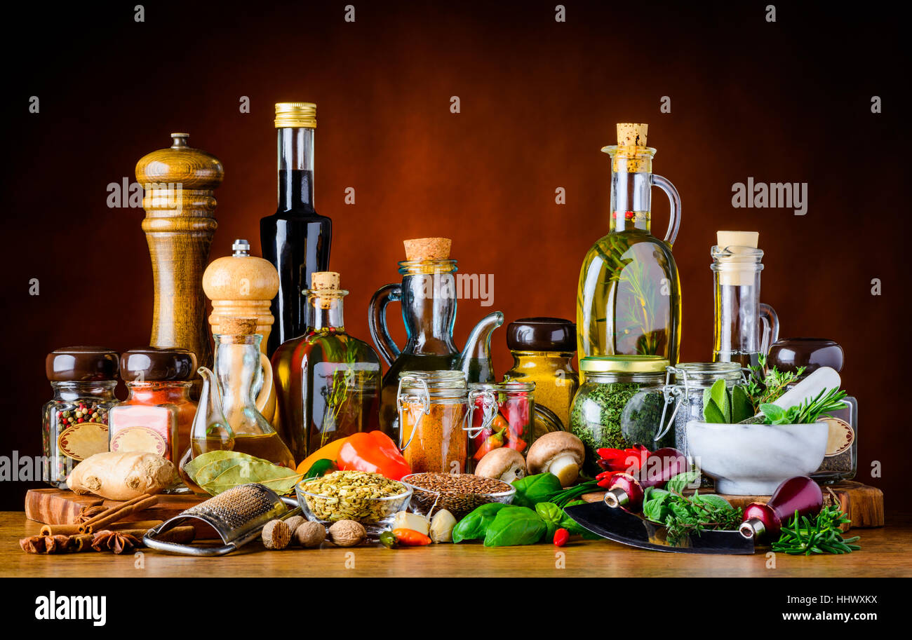 Food Seasoning with different spices, herbs, vegetables, oil in still ...