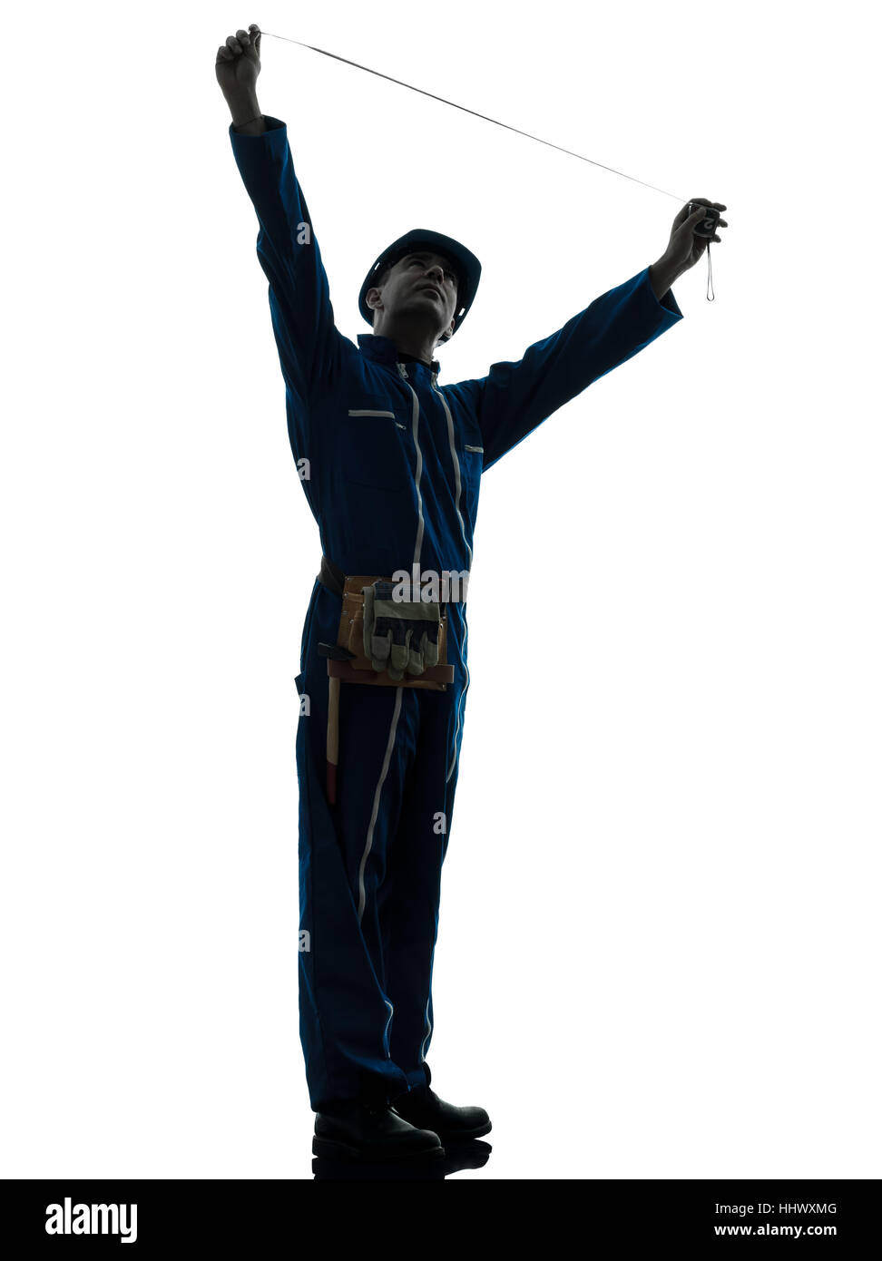 one caucasian man construction worker Tape Measure silhouette in studio ...