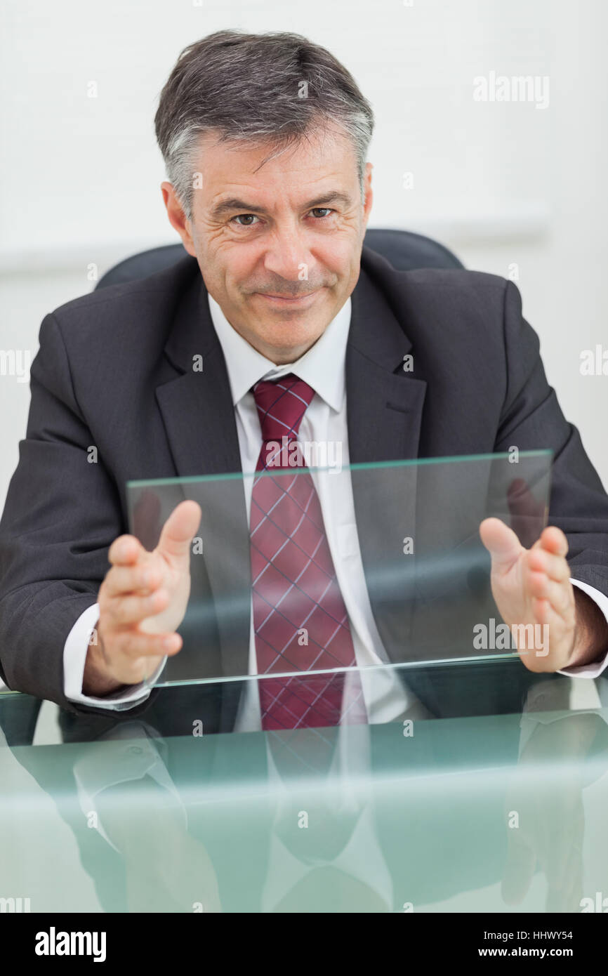 Business man with a virtual screen on his desk in his office Stock ...