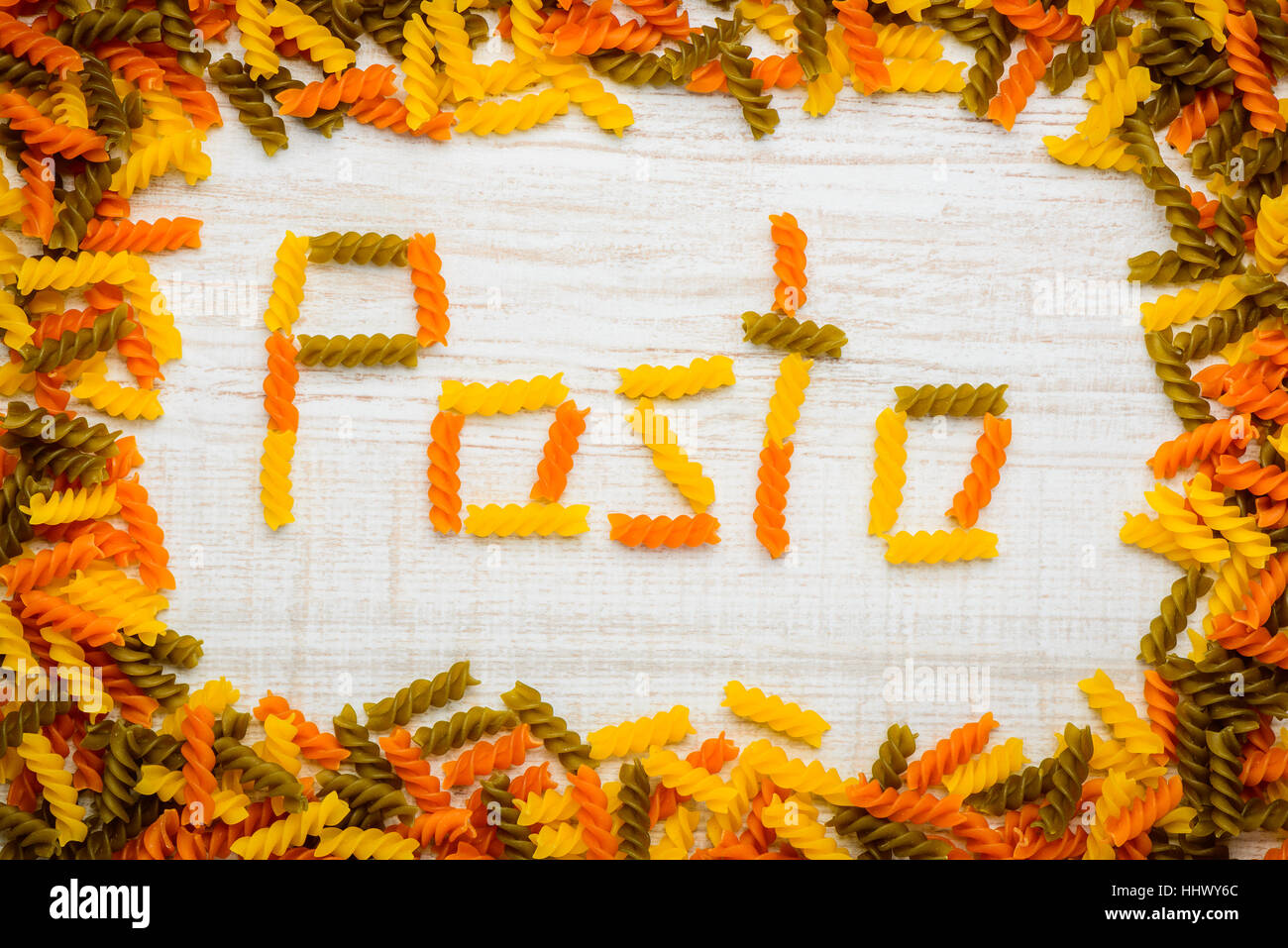 Pasta text out of colored fusilli doppia rigatura pasta Stock Photo - Alamy
