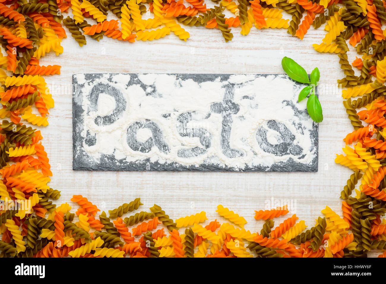 Pasta Text written in white flour with colored Fusilli doppia rigatura ...