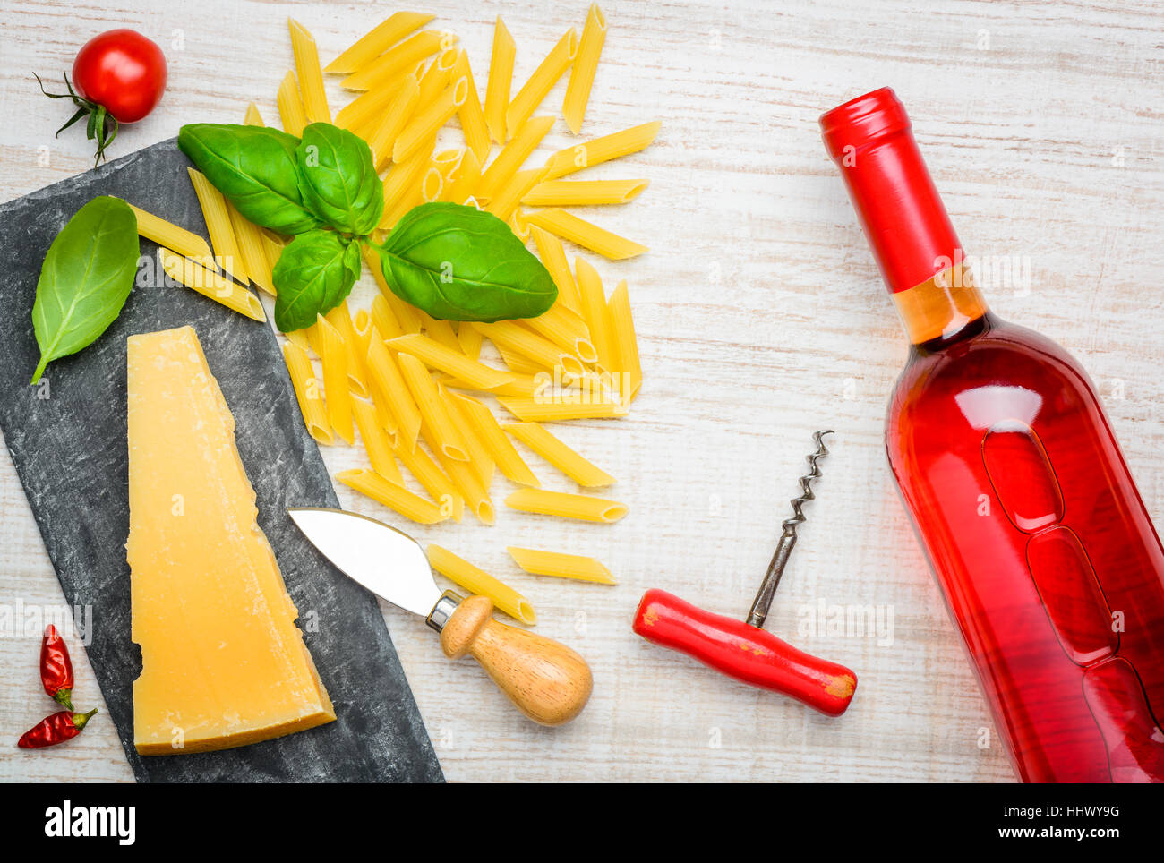 Yellow Parmigiano Reggiano Parmesan hard cheese with penne pasta and a ...