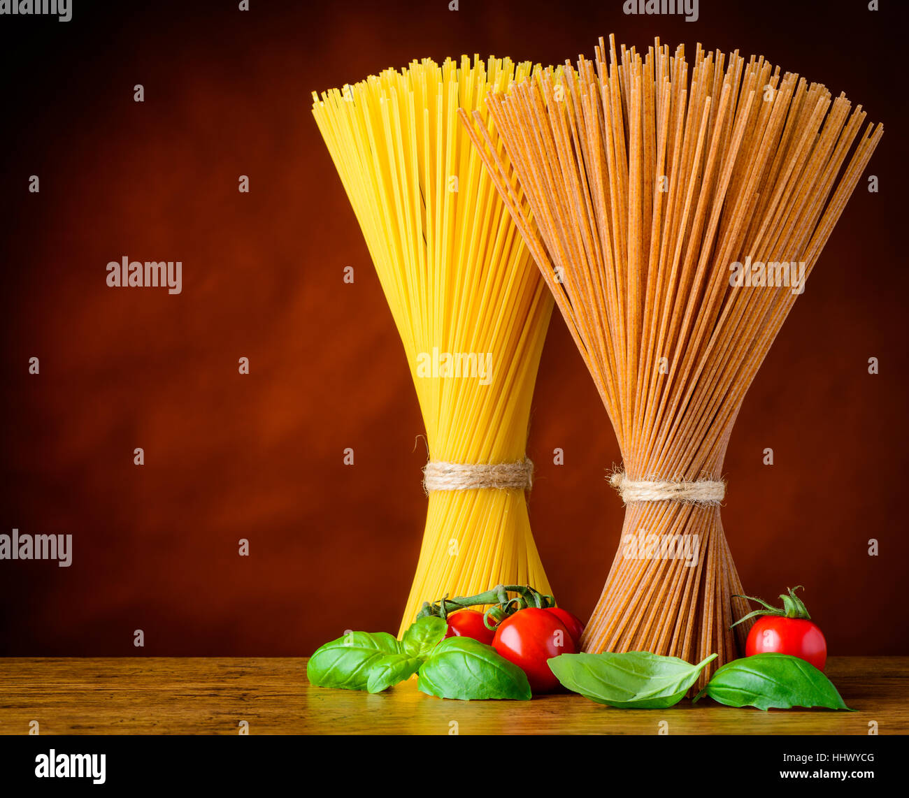 Brown and Yellow Spaghetti Pasta with copy space and tomato Stock Photo ...