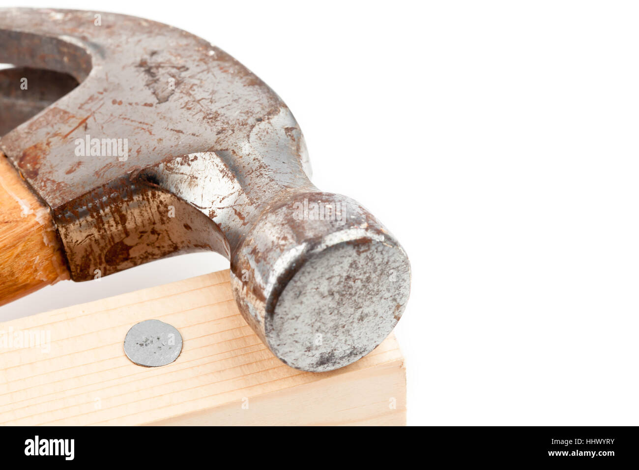 Nail in a wooden board while the hammer is lying on the board Stock ...