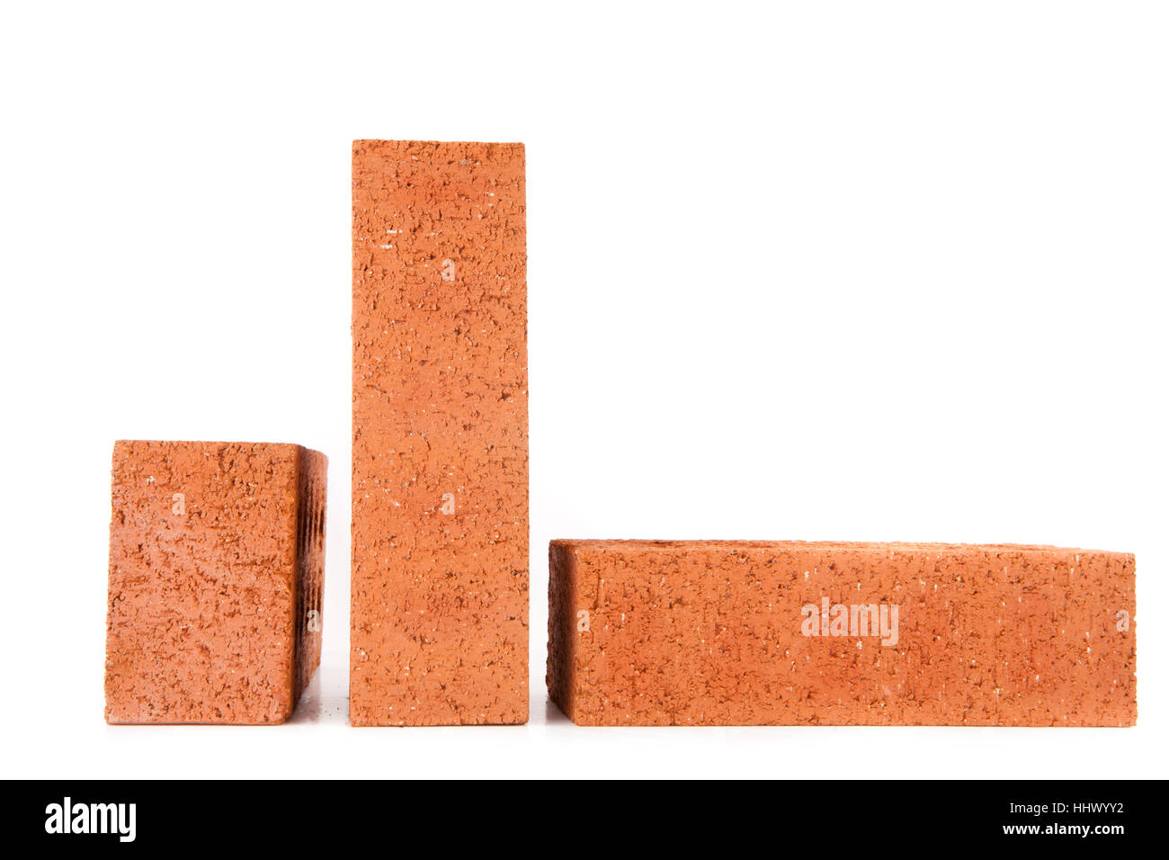Three clay bricks in different sizes against a white background Stock ...