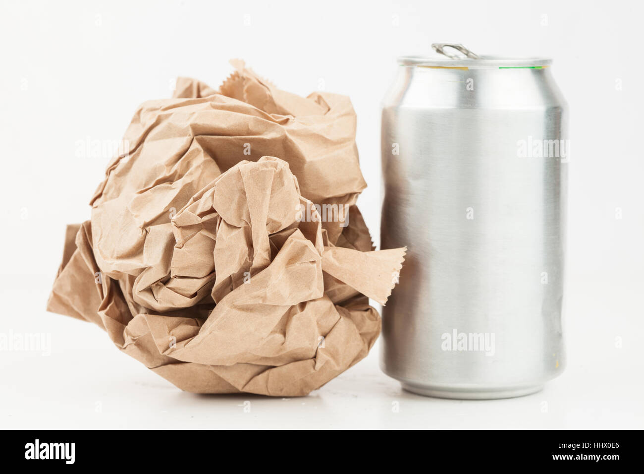 Empty can and crushed paper bag for recycling Stock Photo - Alamy