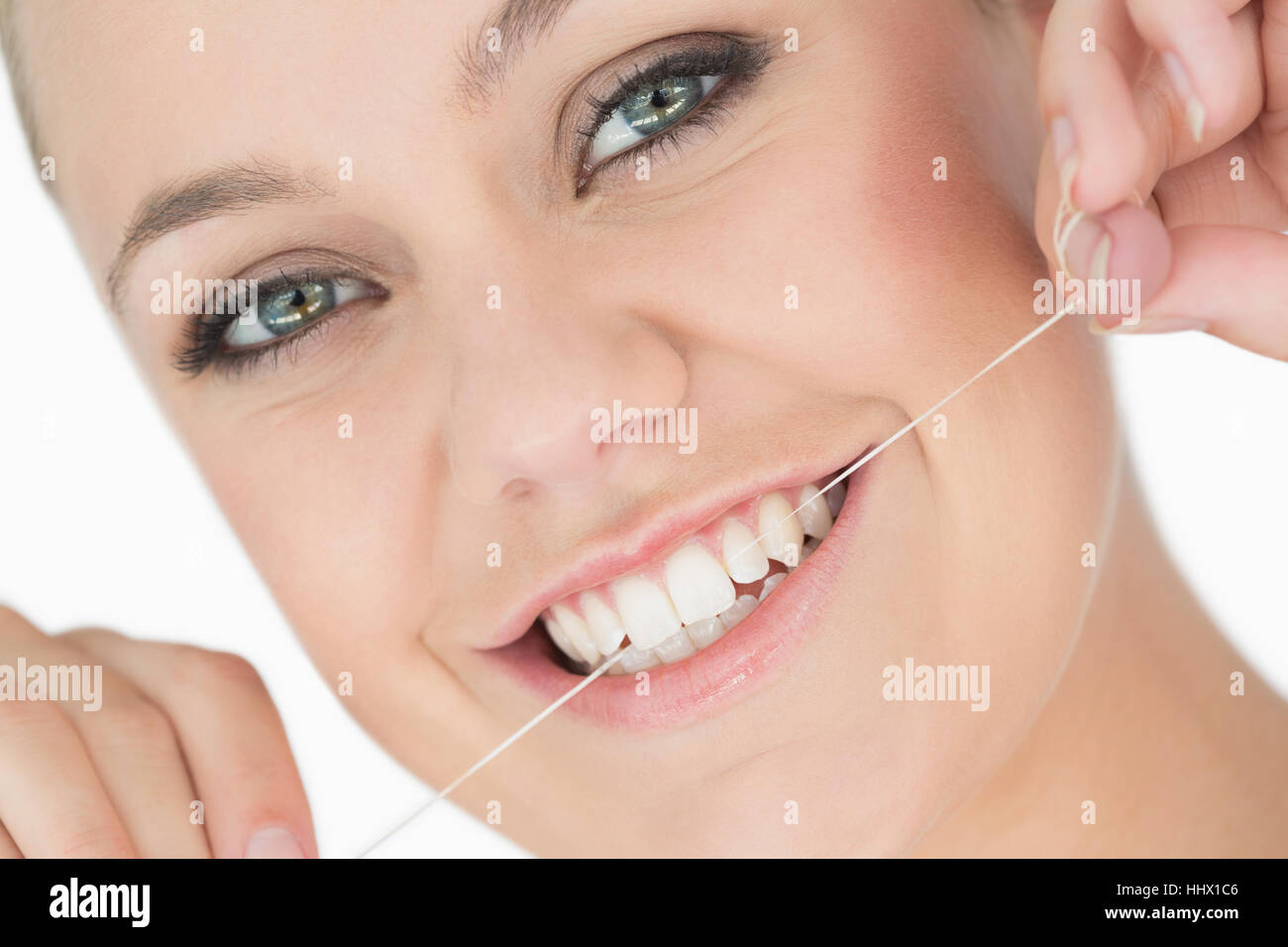 Woman using dental floss in the white background Stock Photo - Alamy