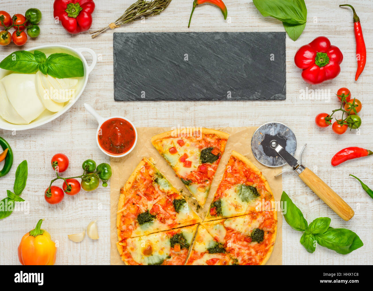 Italian Pizza sliced with Pizza-cutter Wheel and mozzarella cheese and ...