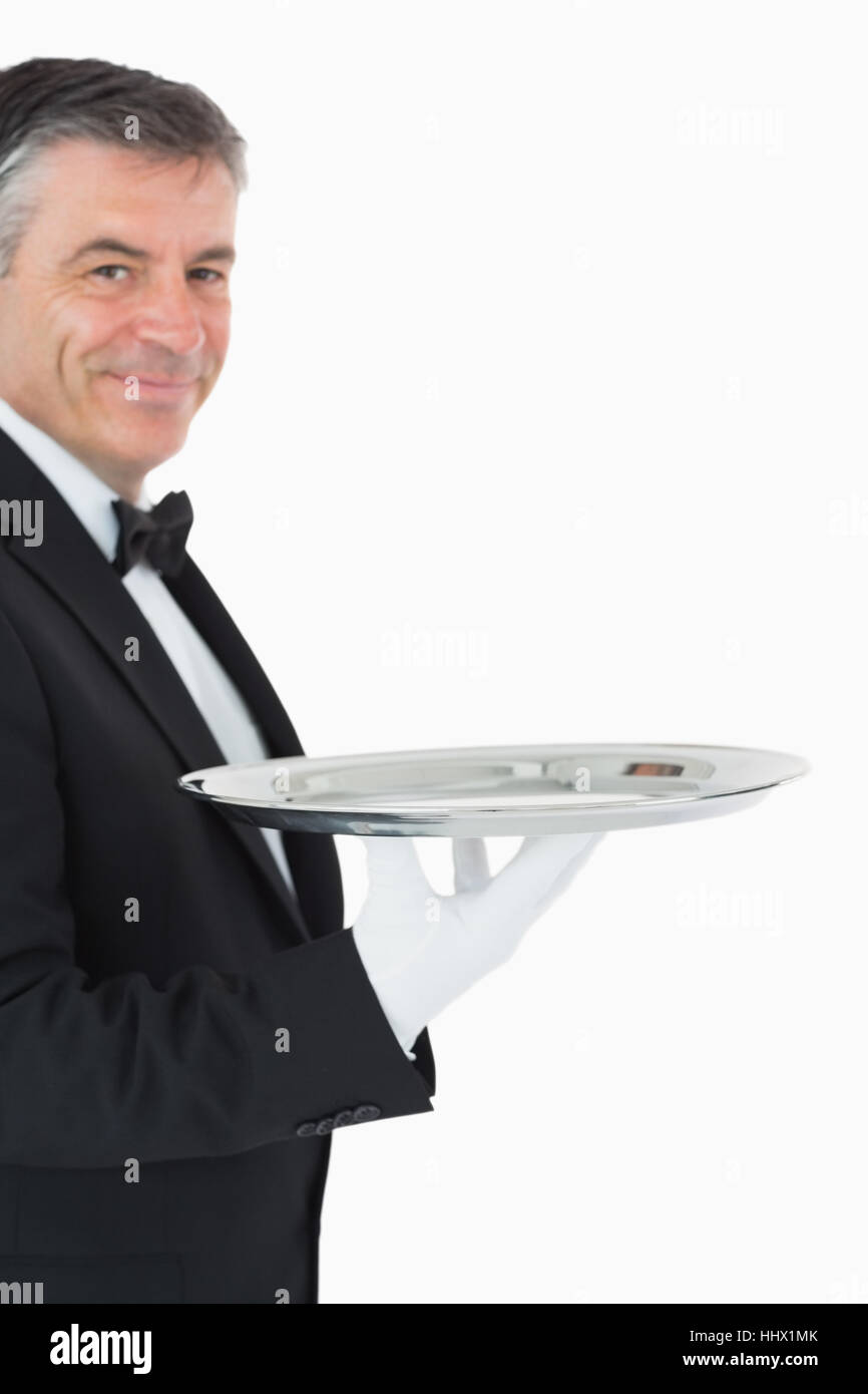 Smiling waiter looking at camera while holding a silver tray Stock ...
