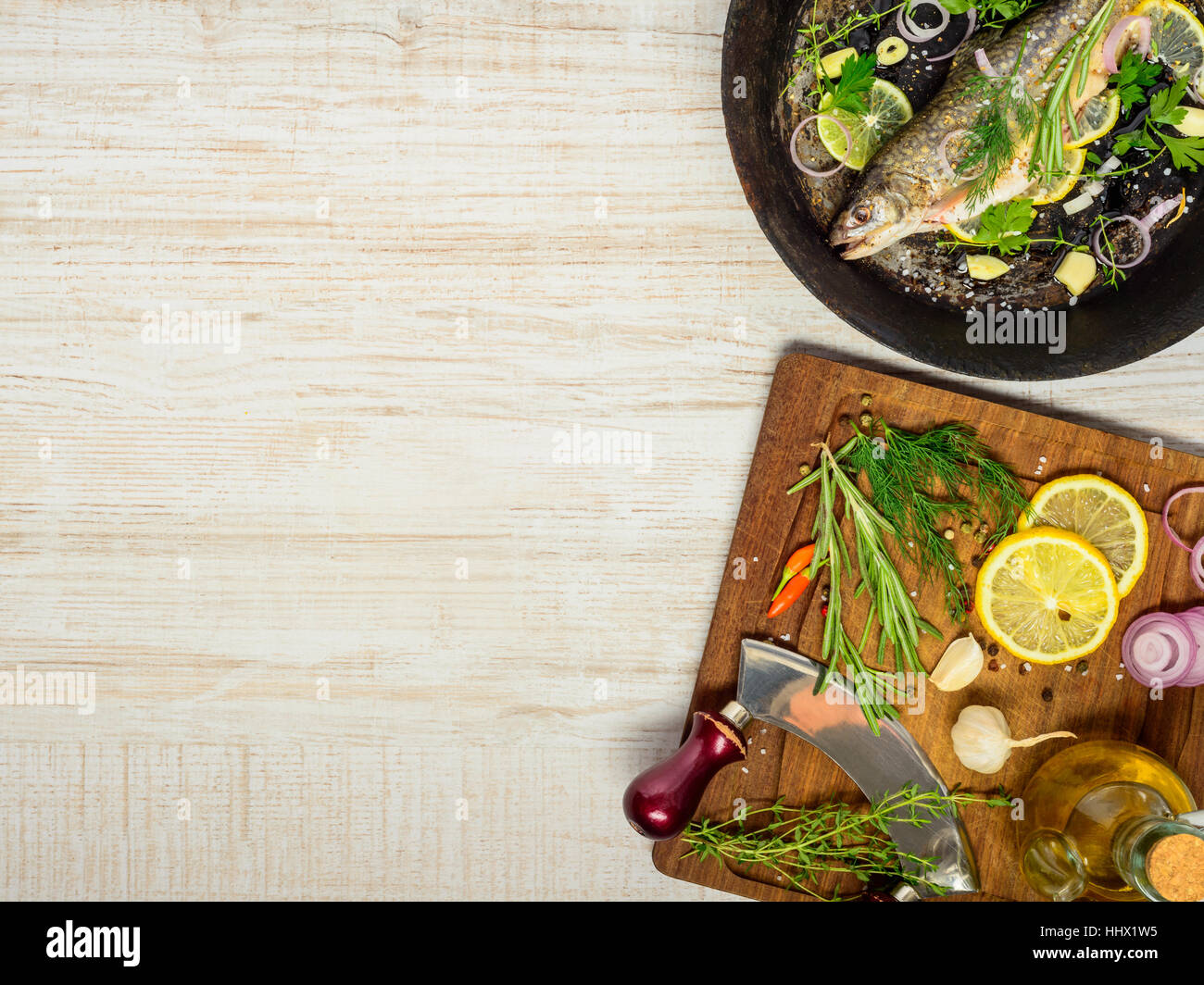 Prepared Fish for Cooking in frying pan and Ingredients on Wooden ...