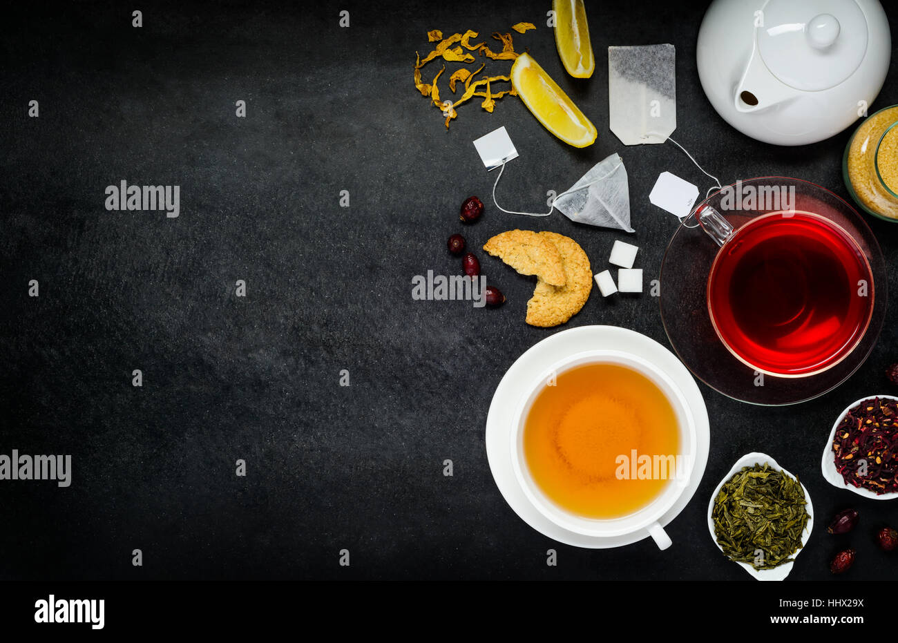 Yellow and Red Tea with white Teapot and Ingredients on Copy Space Area ...