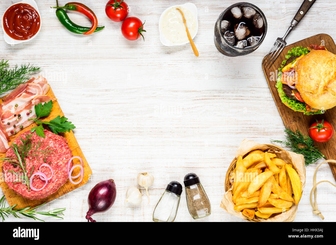 Raw Ground Meat with Fast Food ingredients, burger and French Fries ...