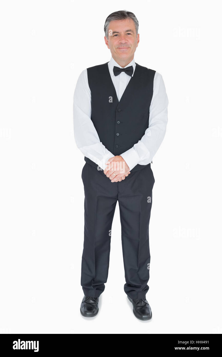 Happy waiter standing in uniform Stock Photo - Alamy
