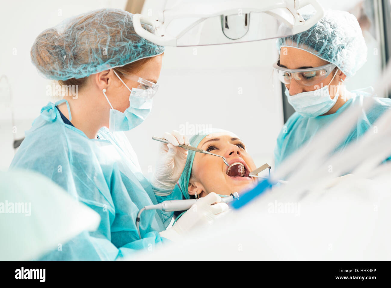 Dentists with a patient during a dental intervention Stock Photo - Alamy