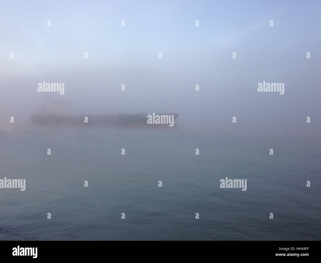 Boat moving in thick fog early winter morning Stock Photo - Alamy