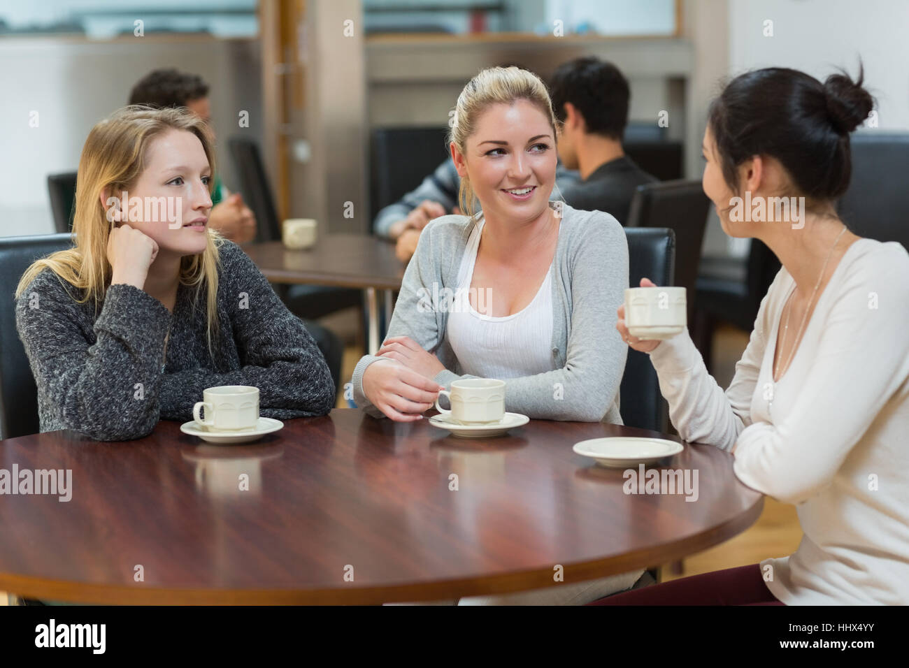 Students talking together in college coffee shop and smiling Stock ...