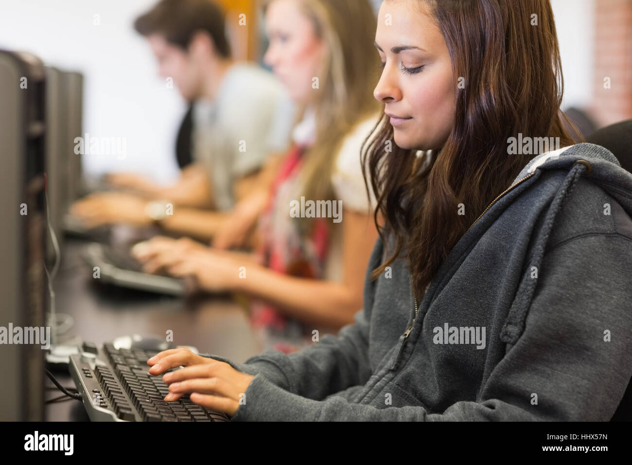 Woman typing in computer room in college Stock Photo - Alamy