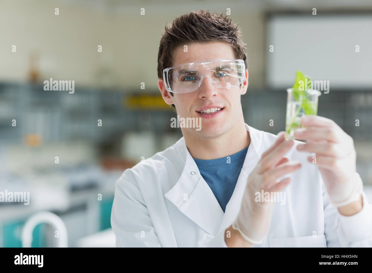 Male scientist smiling holding plants hi-res stock photography and ...