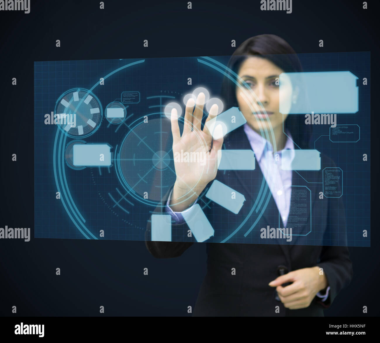 Concentrate woman standing while touching interface hologram Stock ...