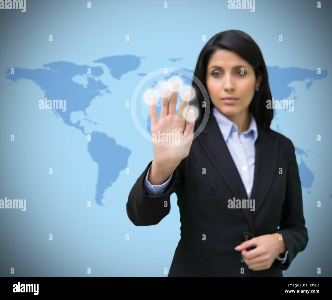 Woman pressing hand to holographic screen against world map Stock Photo ...