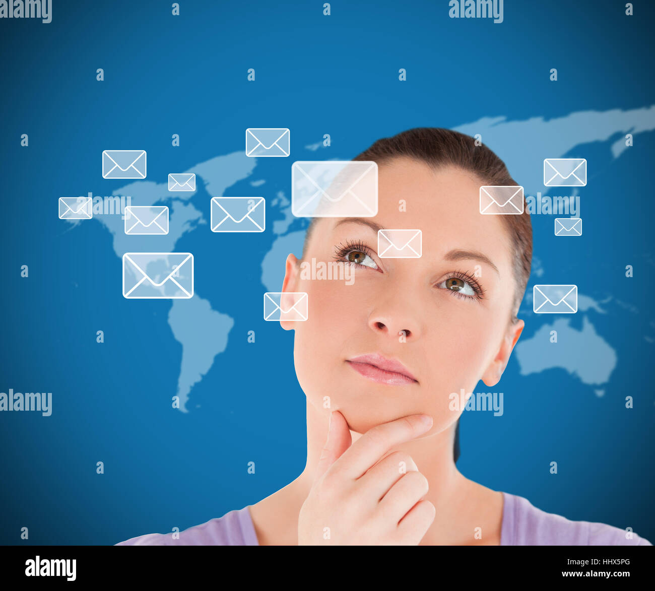 Woman looking at holographic message symbols while thinking Stock Photo ...