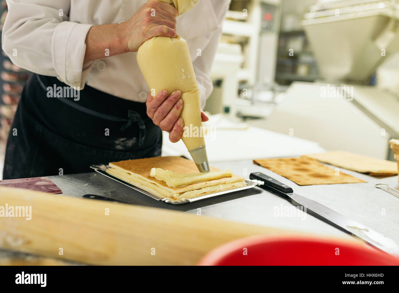 Female pastry chef decorating dessert in the kitchen. Cooking Concept ...