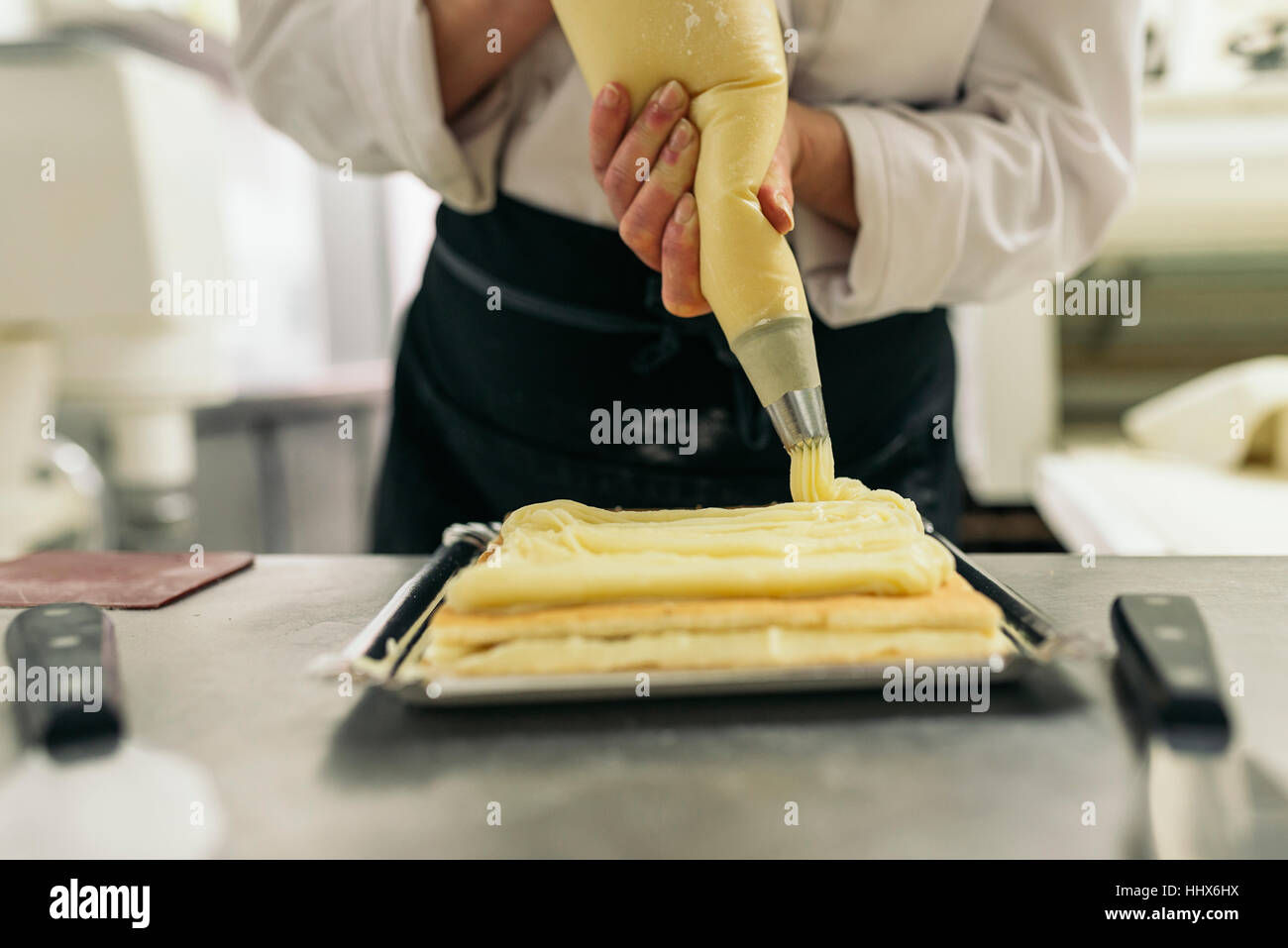 Female pastry chef decorating dessert in the kitchen. Cooking Concept ...