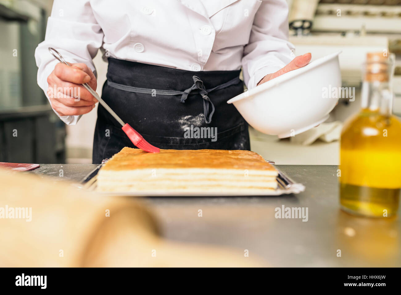 Female pastry chef decorating dessert in the kitchen. Cooking Concept ...