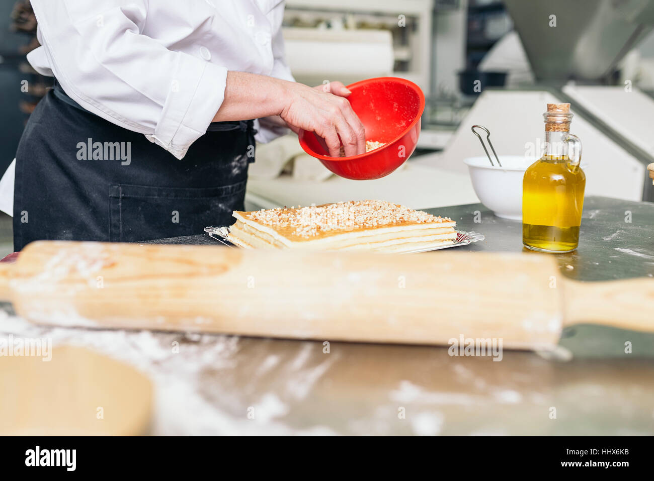 Female pastry chef decorating dessert in the kitchen. Cooking Concept ...