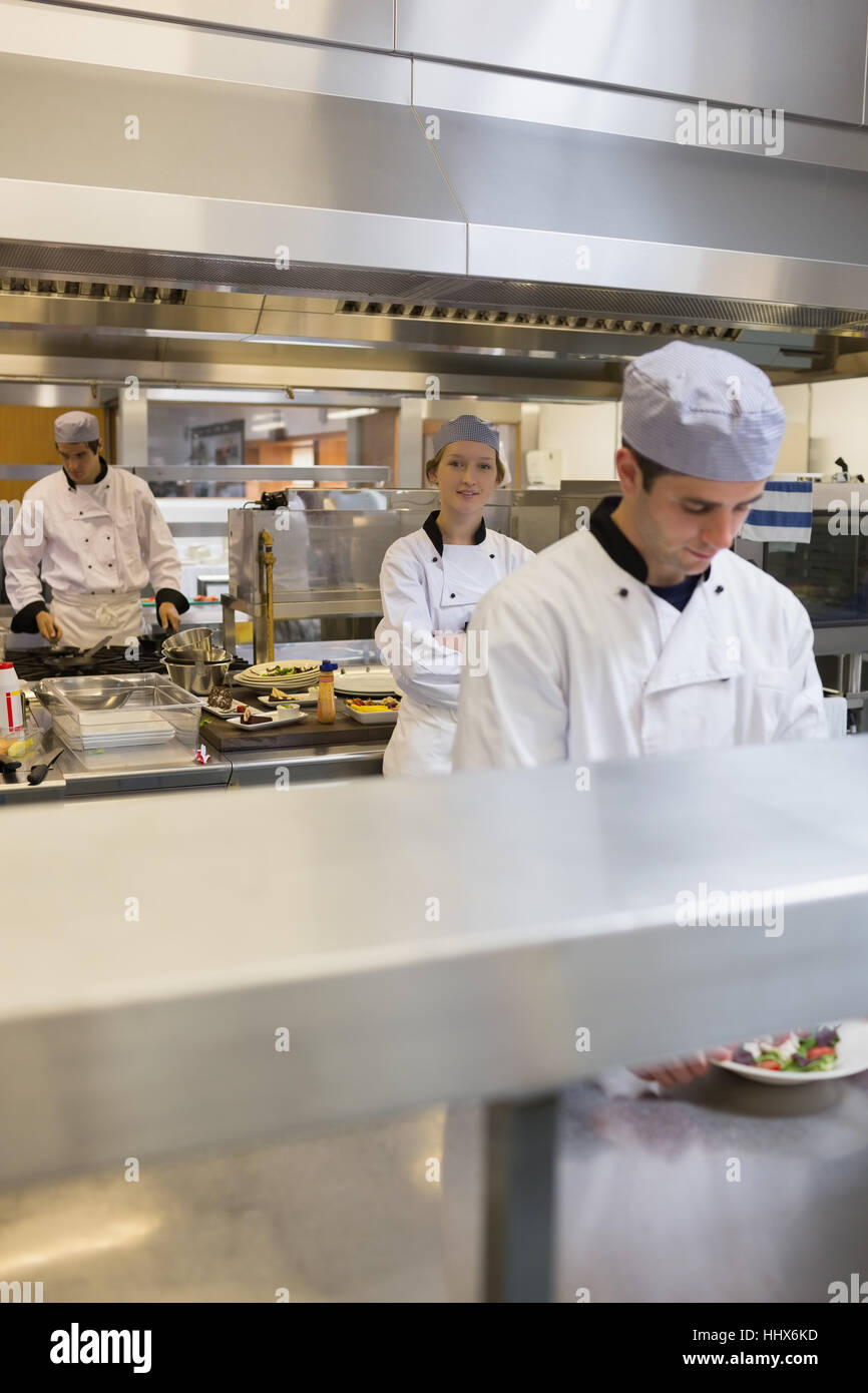 Three Chef's cooking in the restaurant kitchen Stock Photo - Alamy