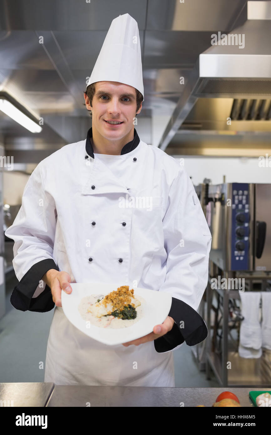 Chef presenting his plate in the kitchen Stock Photo - Alamy