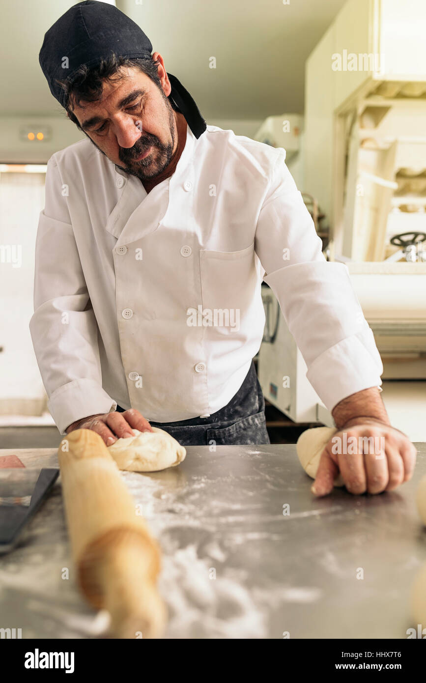 Baker kneading dough in a bakery. Bakery Concept Stock Photo - Alamy