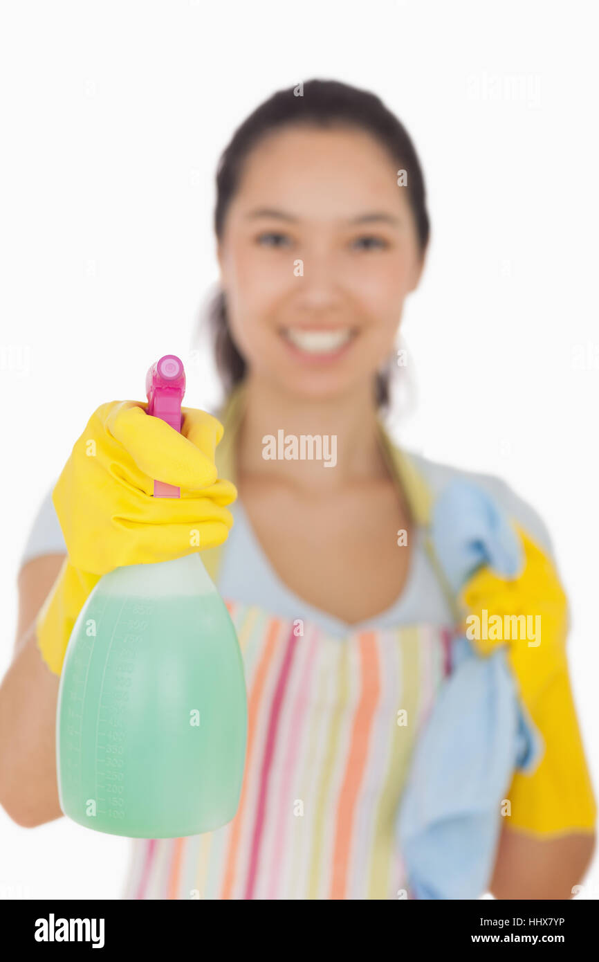 Smiling woman in apron and gloves holding spray bottle and cloth Stock ...