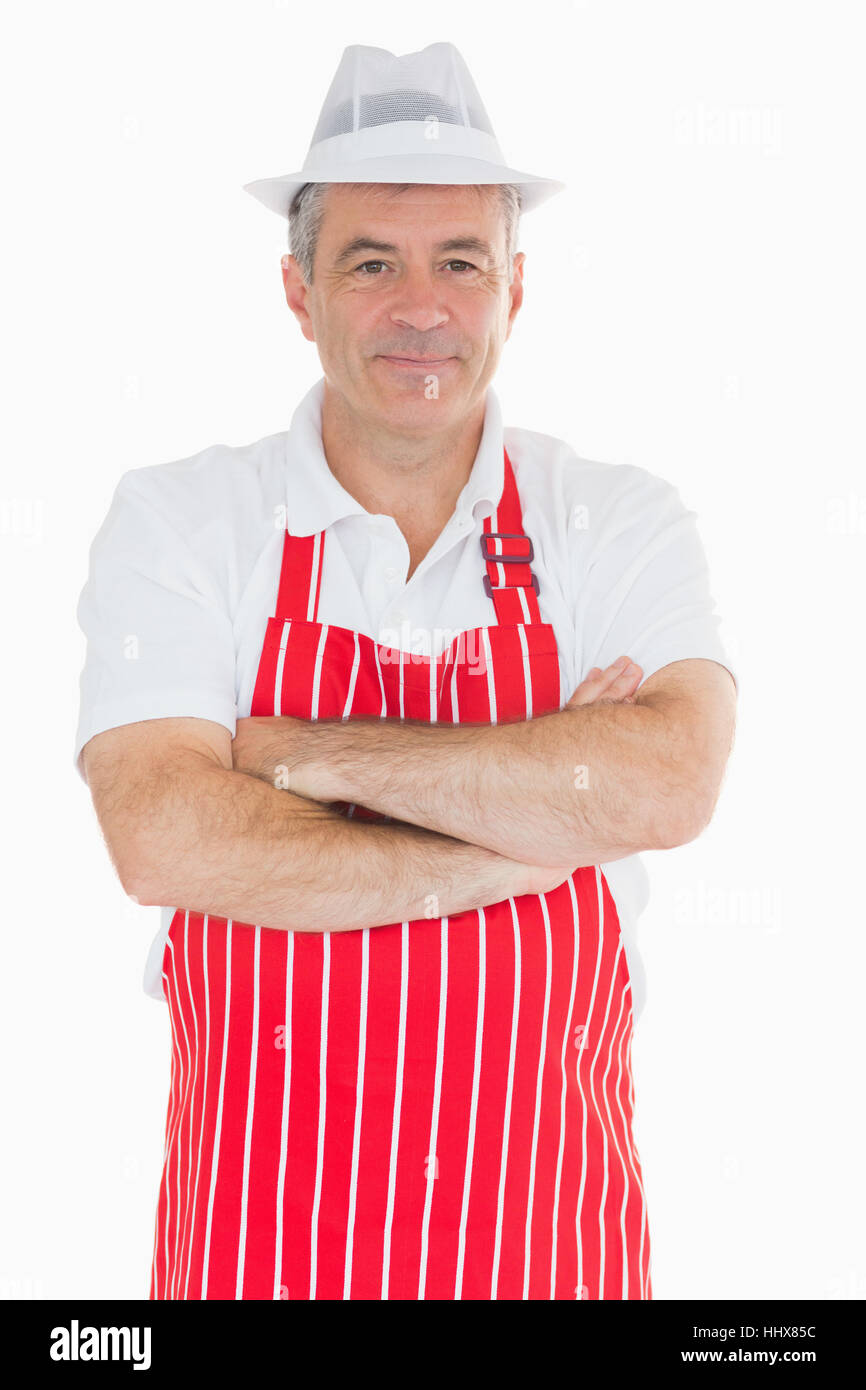 Smiling butcher with crossed arms Stock Photo - Alamy