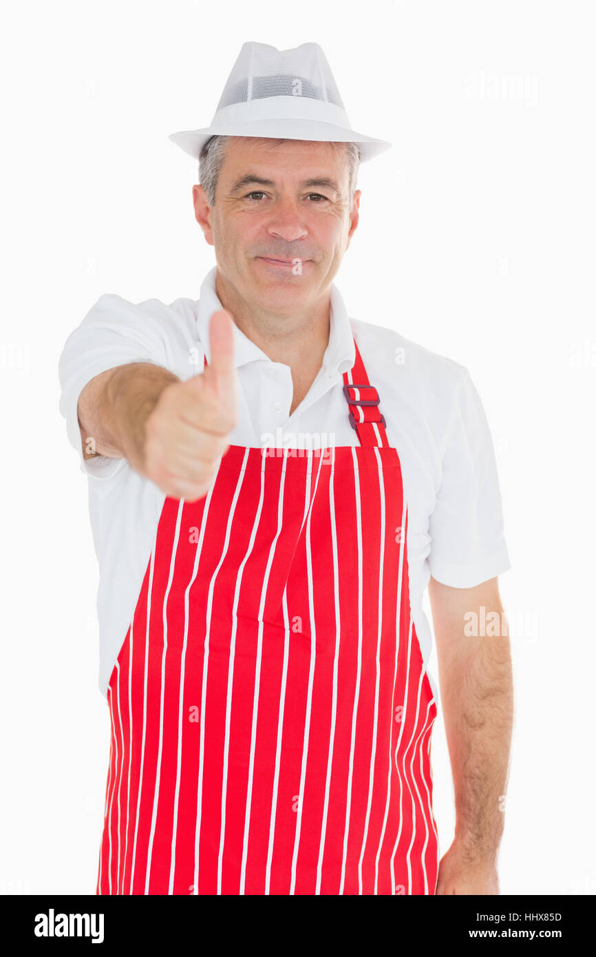 Smiling butcher giving thumbs up Stock Photo - Alamy