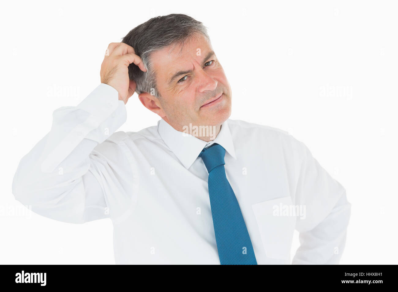 Puzzled businessman scratching his head Stock Photo - Alamy