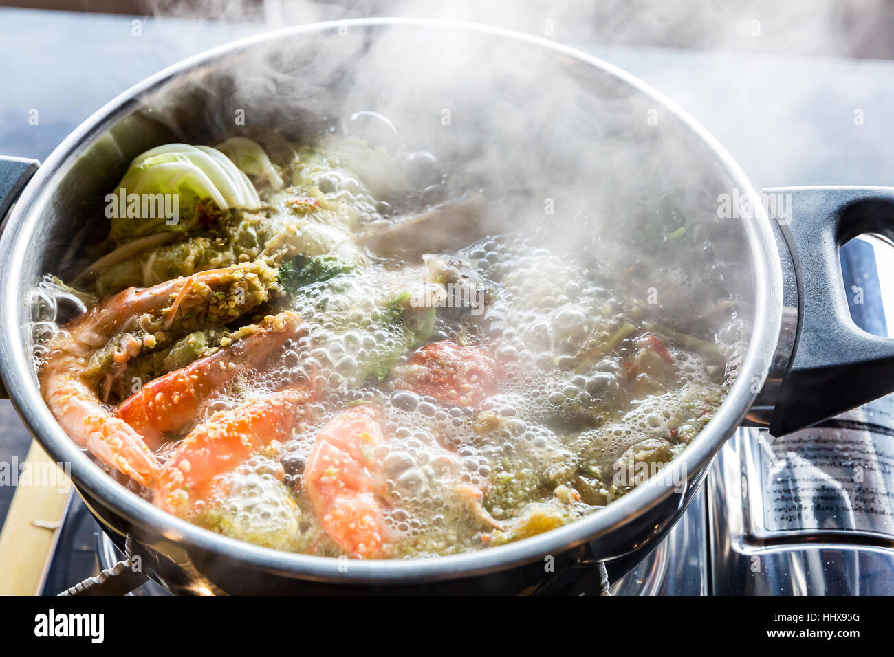 Seafood spicy hot pot crab prawn fish squid tumyum Stock Photo - Alamy