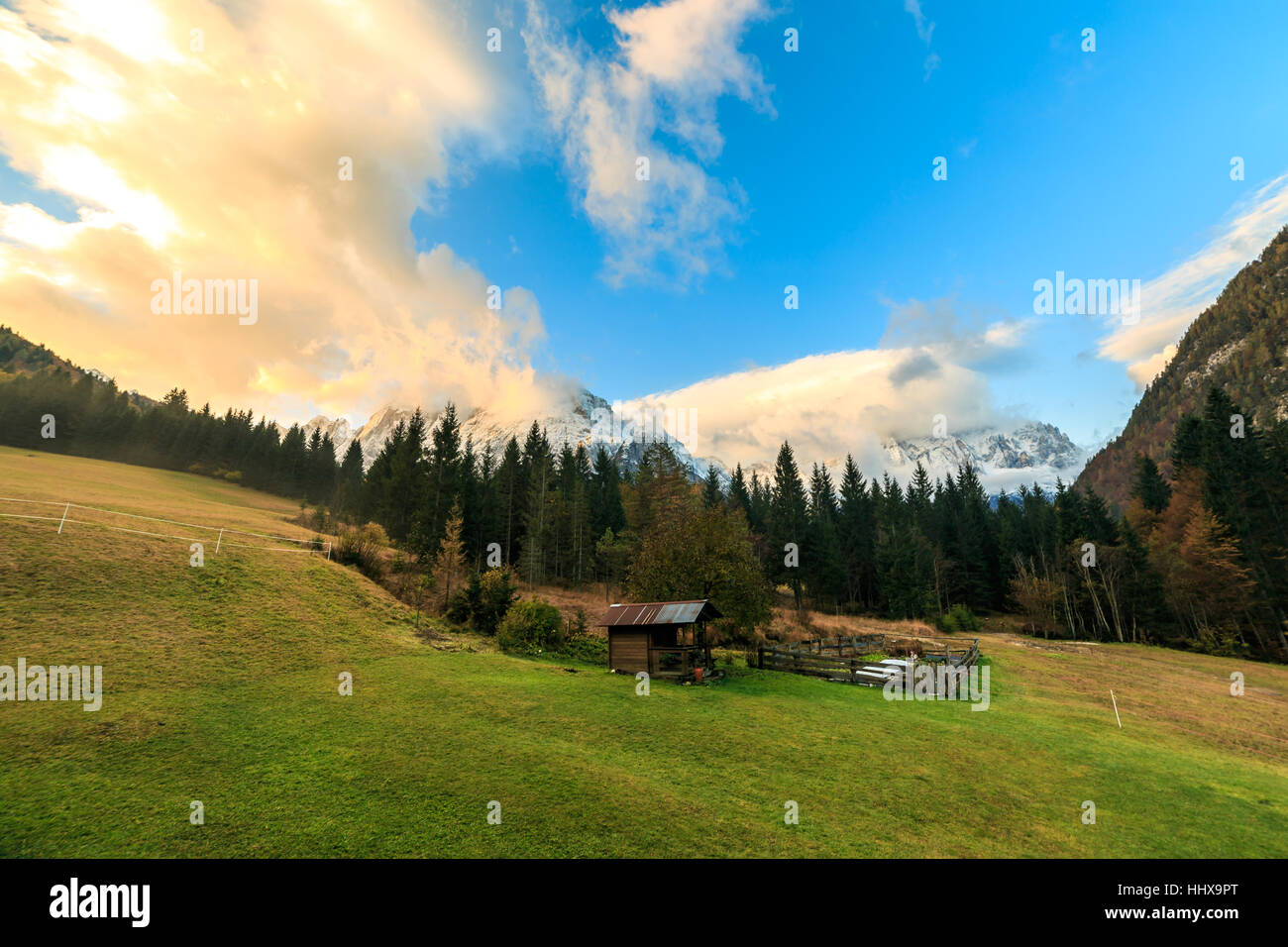 an alpine hut in the valley during a colorful sunrise Stock Photo - Alamy