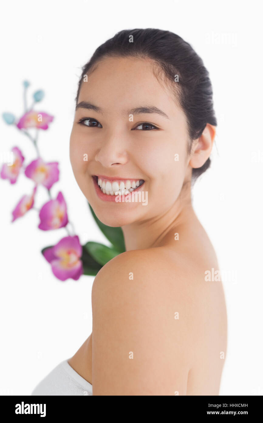 Smiling natural beauty with orchids Stock Photo - Alamy