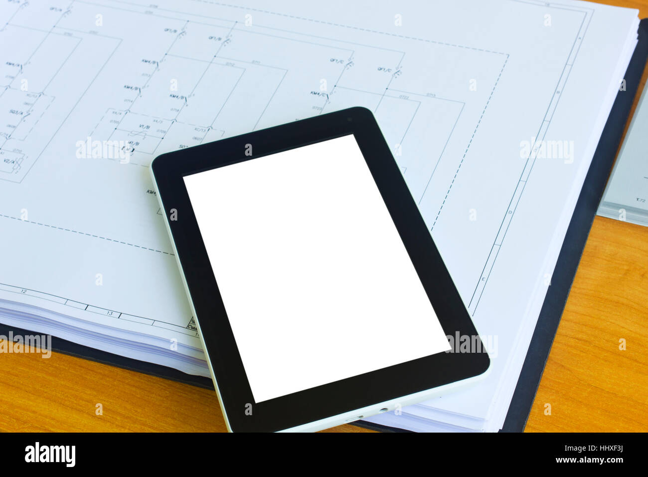 Tablet computer over engineering journal Stock Photo - Alamy