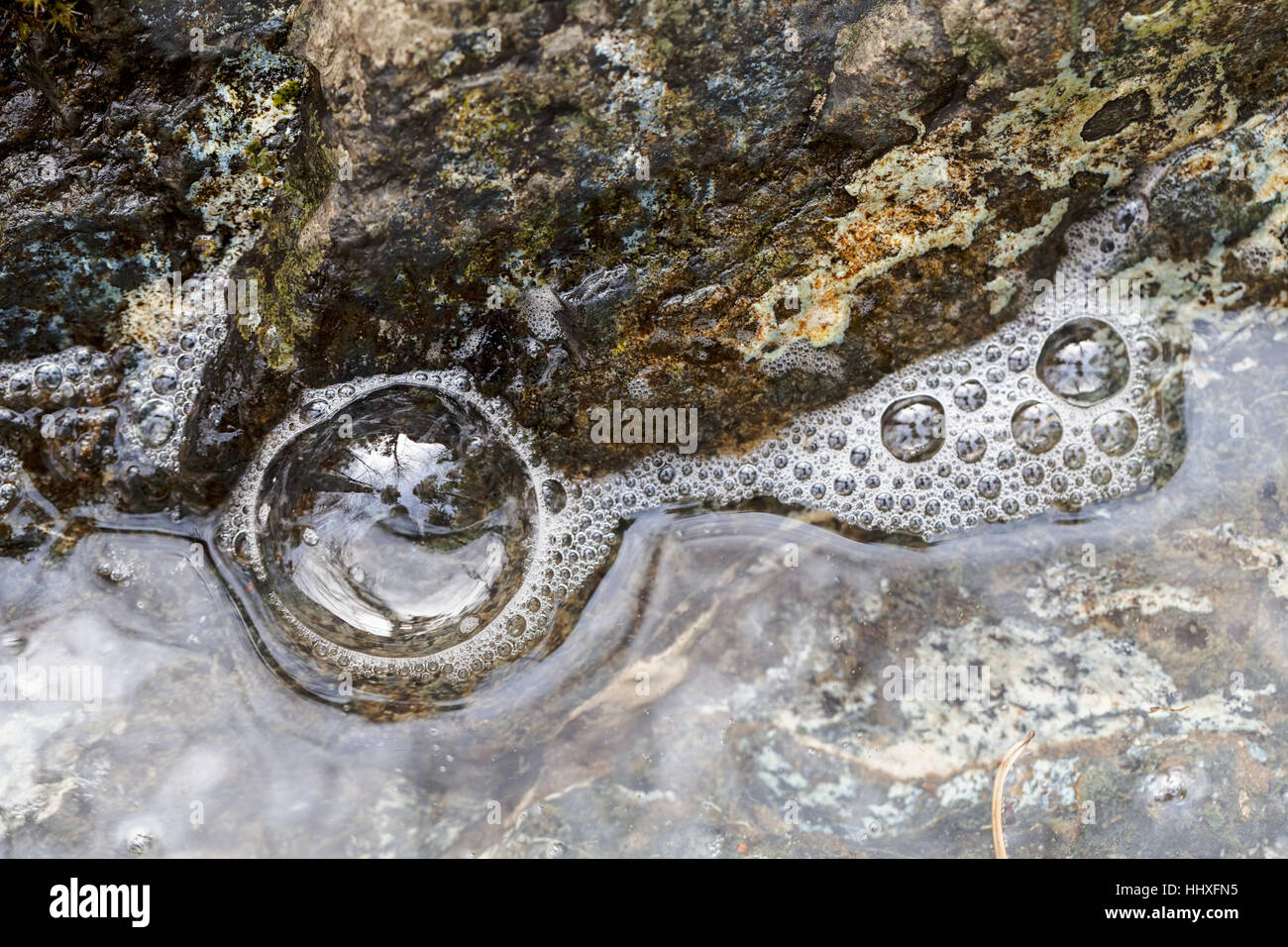 stone under the sparkling mountain water, note shallow depth of field ...