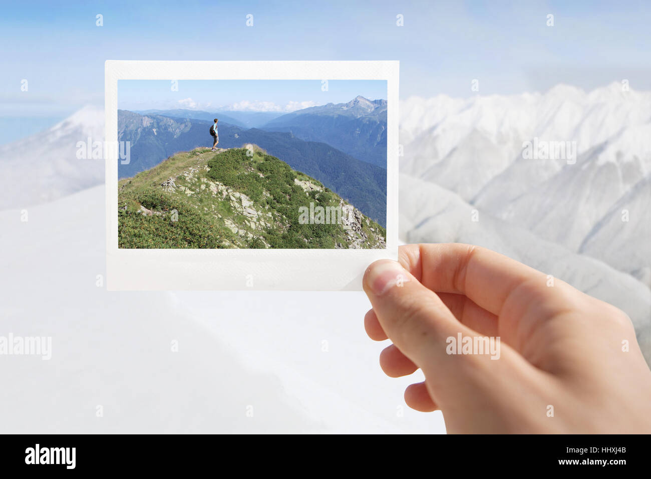 Holding Instant photo on a winter background Stock Photo - Alamy